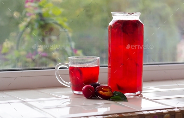 Summer lemonade made from fresh cherry plums, plums in a large glass ...