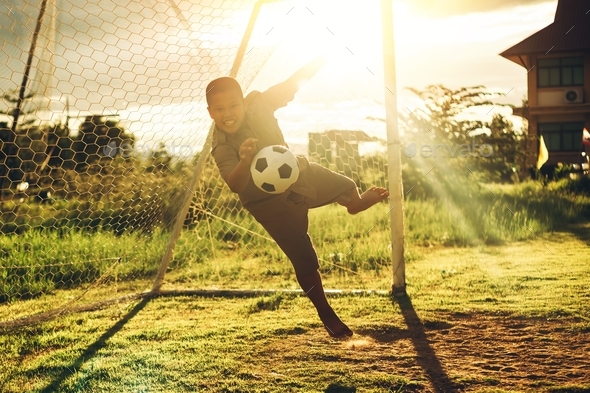 sport outdoors of a group of kids having fun playing soccer football ...
