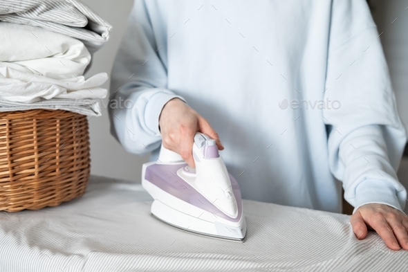 Close-up woman ironing clean linen on the ironing board Stock Photo by ...