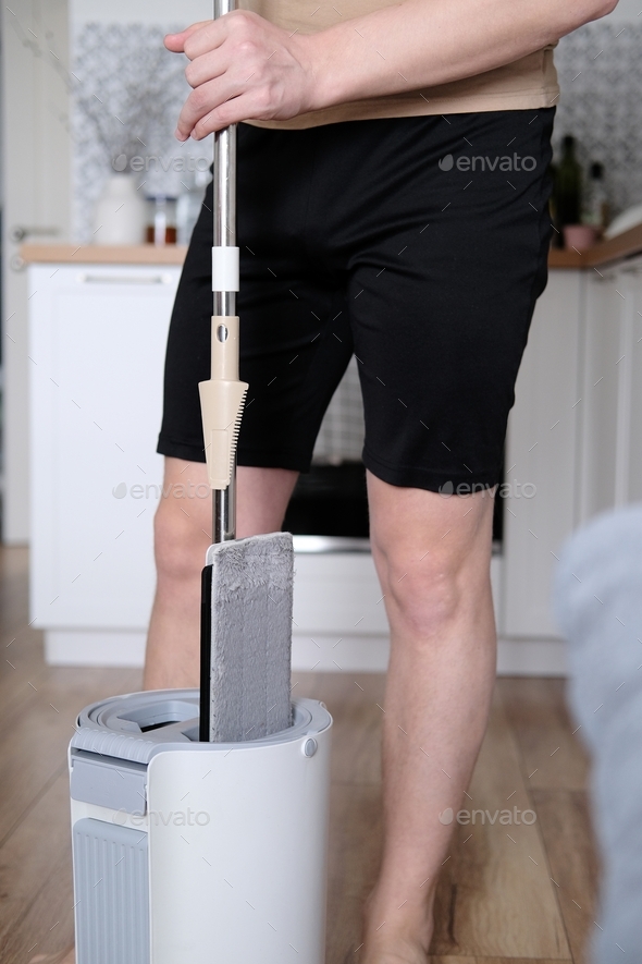 Man drying mop in modern bucket Stock Photo by rekaolya | PhotoDune