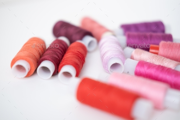 Sewing machine threads in red colors Stock Photo by rekaolya | PhotoDune