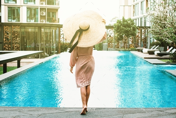 Woman in huge straw hat near swimming pool. Back view Stock Photo by ...