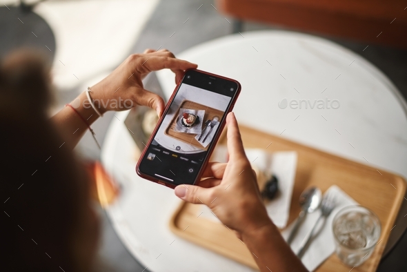 Making snapping food at the restaurant by phone Stock Photo by olgapink