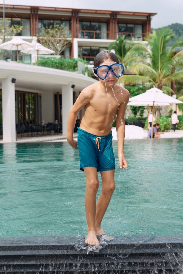 10 year old teenage boy jumping into the swimming pool water. Kids ...