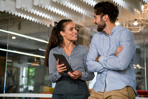 Successful business people, designer enjoying work together. Business ...