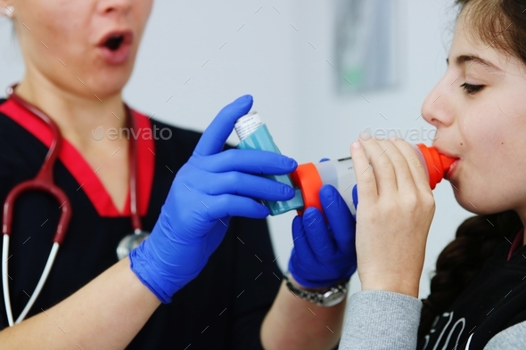 Helping the paediatric patient to use a puffer Stock Photo by lira_n4