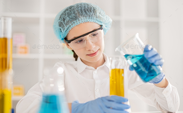 Girl mixing chemical substances in laboratory Stock Photo by kegfire