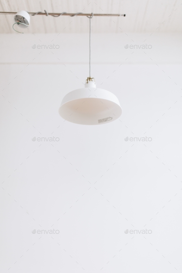 Modern white light hanging on a white ceiling Stock Photo by KatieLMayne