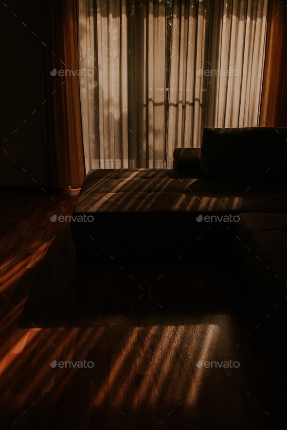 Sun rays through the windows of the living room Stock Photo by oaravoicu