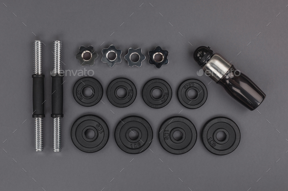 top view of various metal barbells and weights with shaker isolated on ...