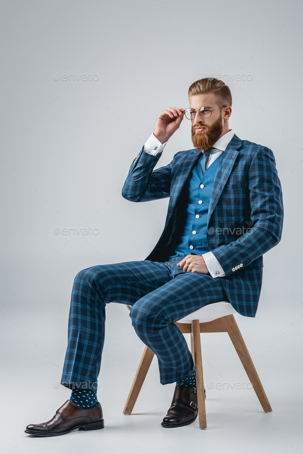 handsome man in blue suit sitting on chair isolated on grey Stock Photo ...