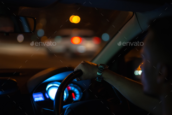 The man drive a car in the night time. Left side traffic Stock Photo by ...