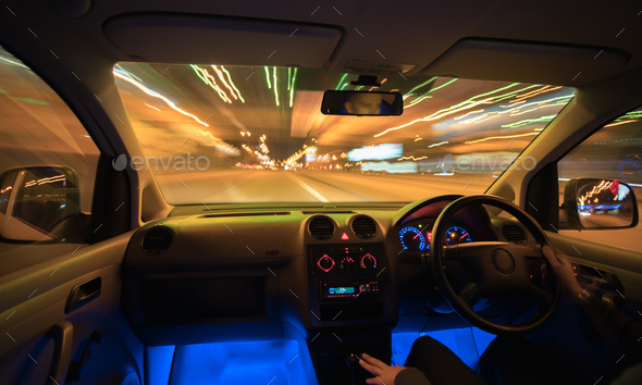 The man drive a car in the city. Evening night time. Left side traffic ...