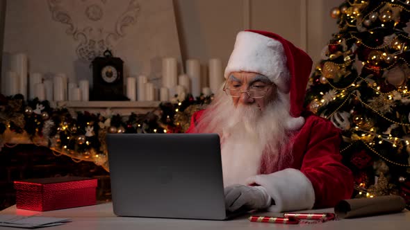 Modern Santa Claus Uses Laptop Buys Christmas Gifts for Children on ...