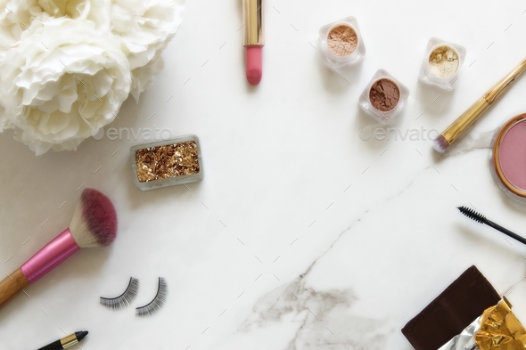 Make up counter with cosmetics, flowers and chocolate Stock Photo by ...