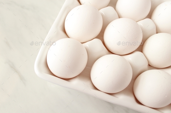 White eggs in white ceramic egg keeper Stock Photo by MPPLLC45 | PhotoDune