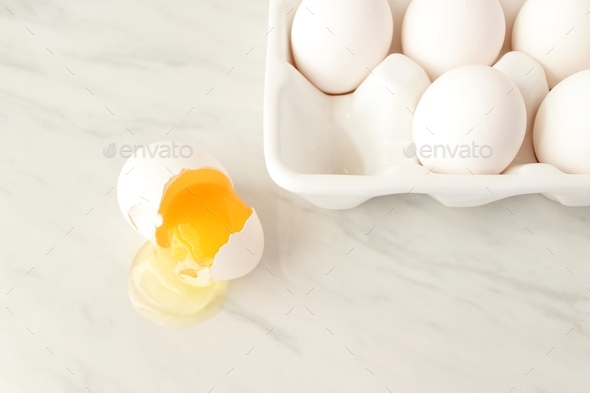 Cracked open egg with egg carton Stock Photo by MPPLLC45 | PhotoDune
