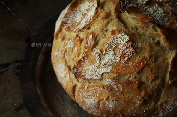 Close up above view of round loaf of artisan bread. Stock Photo by MPPLLC45