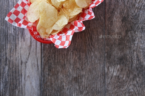 Picnic food basket filled with Potato chips. Copy space. Stock Photo by ...
