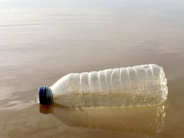 empty plastic bottle in a rain puddle Stock Photo by andreajoseph2011