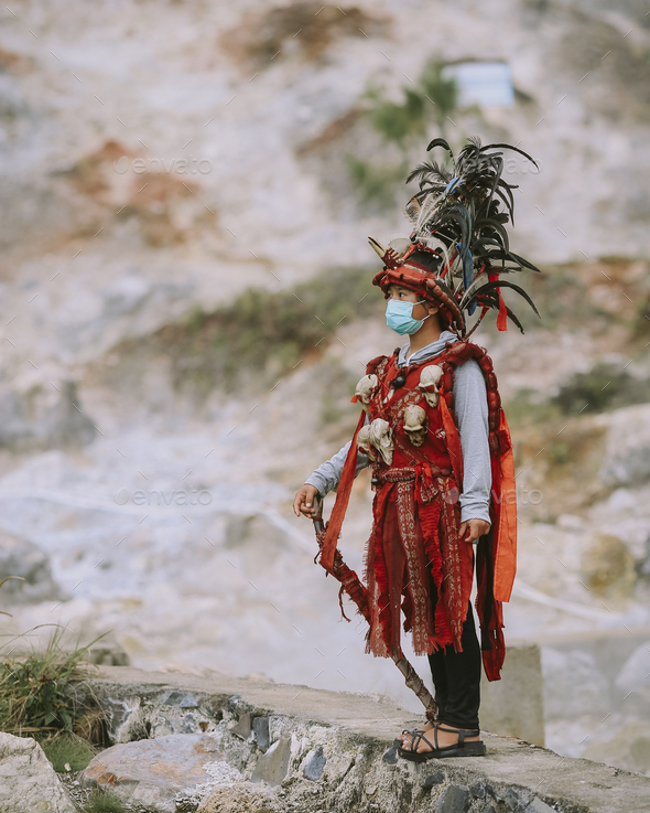 Child using medical mask and traditional dance kabasaran costume Stock ...