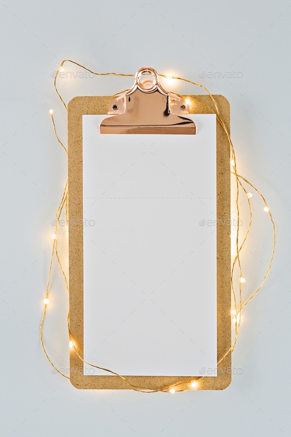 Blank notes sheet on clipboard with led-lights on white background ...