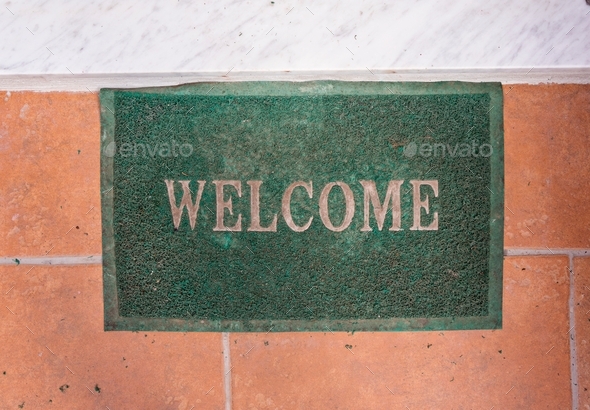 The dirty green doormat with welcome sign text Stock Photo by Kira_Yan