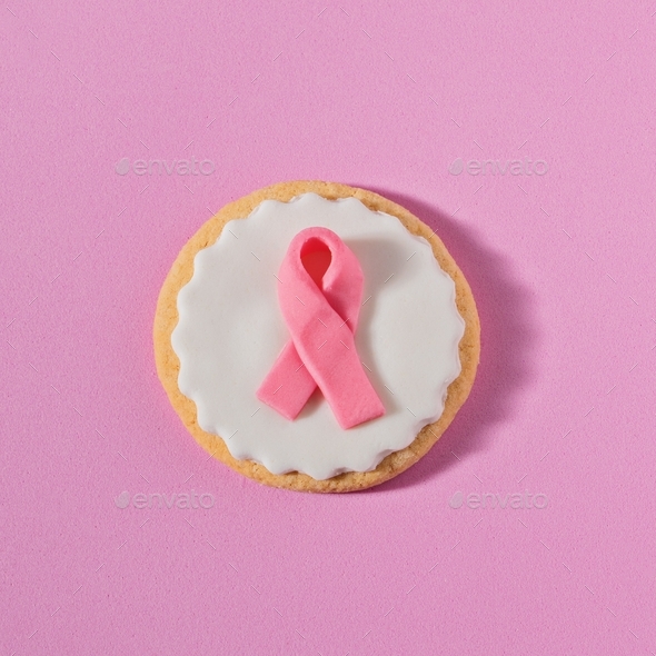 Closeup cookies with pink ribbon as sign of the fight against breast ...
