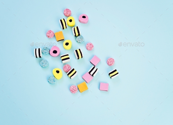 Colored jelly candy scattered on blue background, abstract background ...