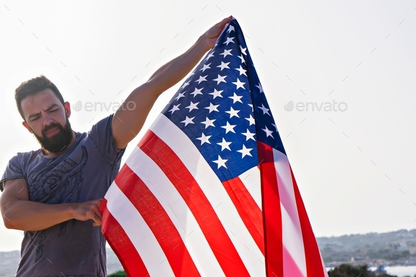 Independence day of United States of America. Mans raised hands with ...