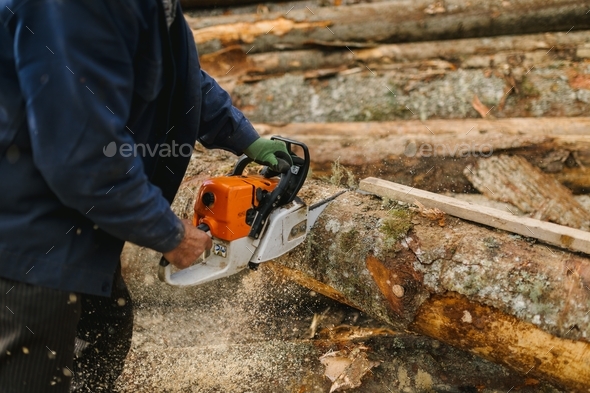 Detail of a woodworker cutting the wood and sawdust flying around with ...