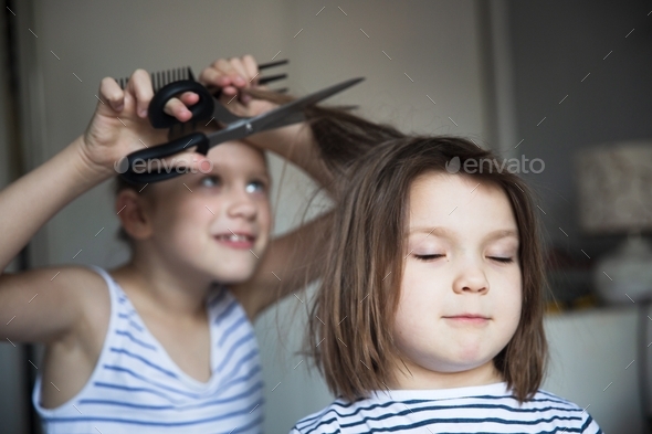 Sister with scissors and hairs Caucasian child. Funny photo, joke and ...