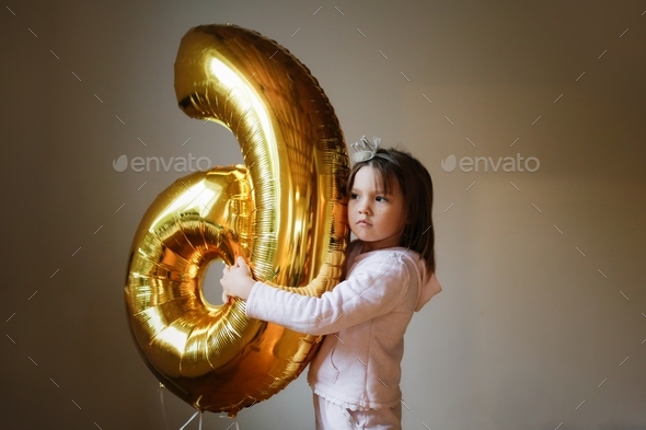 Emotional sad girl child embrace balloon number 6, Stock Photo by ...