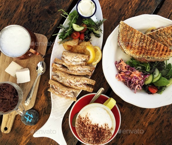 A flat lay of a healthy lunchtime table with seafood sandwiches, Panini ...