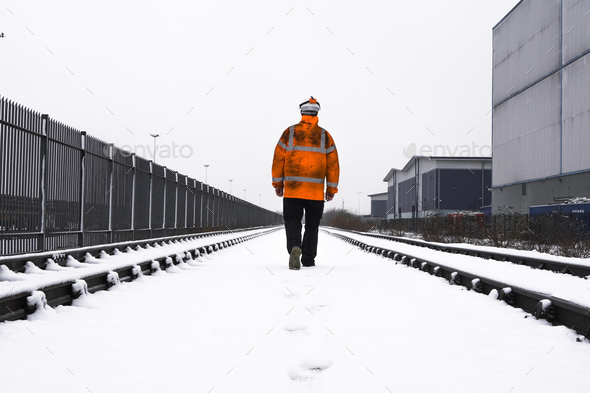 Railway worker security guard patrolling an Industrial area in Winter ...