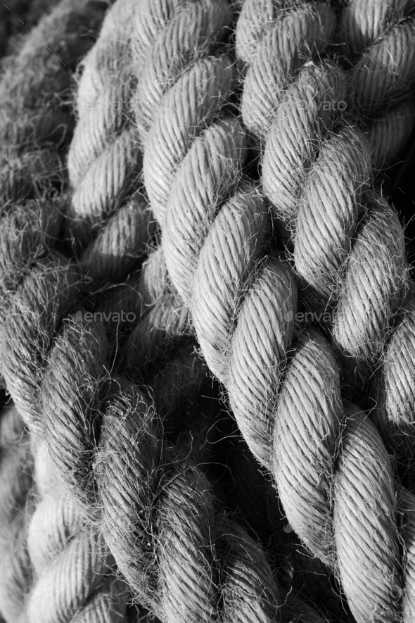 Thick and heavy rope that is worn and frayed in a nautical close up or ...