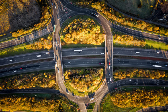 Aerial view directly above a busy motorway with a roundabout overpass ...