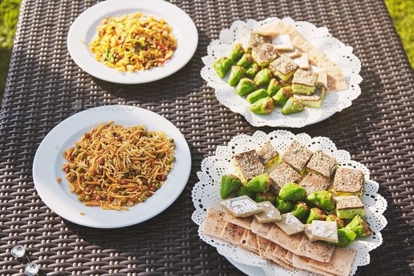 Variety of Indian sweet dish dessert made from bean on the weave wooden ...