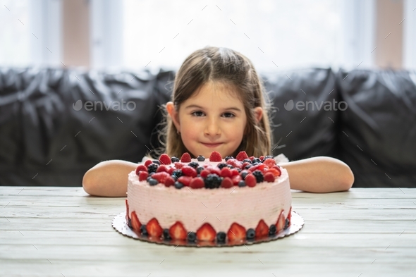 Little girl with a birthday cake.Home made cake with berries Stock ...