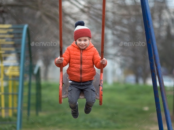 the boy is playing on the playground, he is having fun Stock Photo by ...