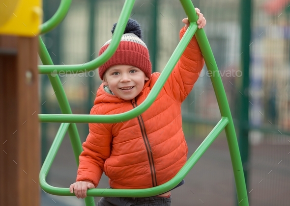 the boy is playing on the playground, he is having fun Stock Photo by ...