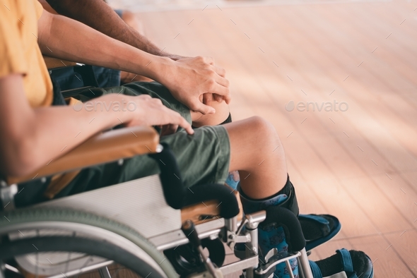Handicapped children in wheelchairs hold their parents' hands. Stock ...
