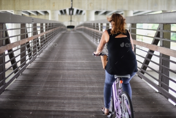 Woman enjoying casual bike ride on trail in Illinois Stock Photo by ...