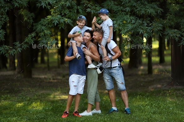 a young woman and a young man and their three sons. family portrait ...