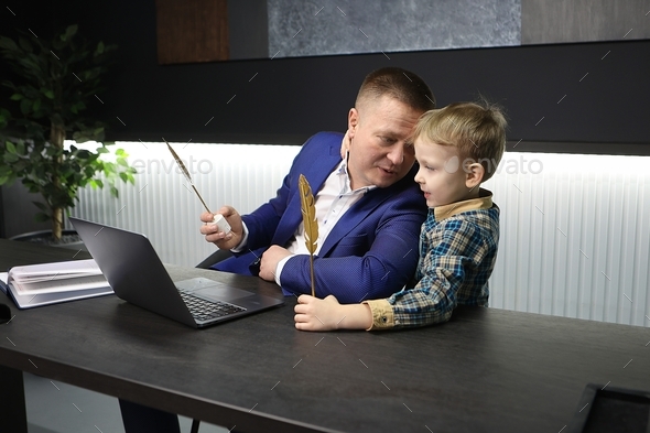 dad and son in the father's office at his workplace Stock Photo by ...