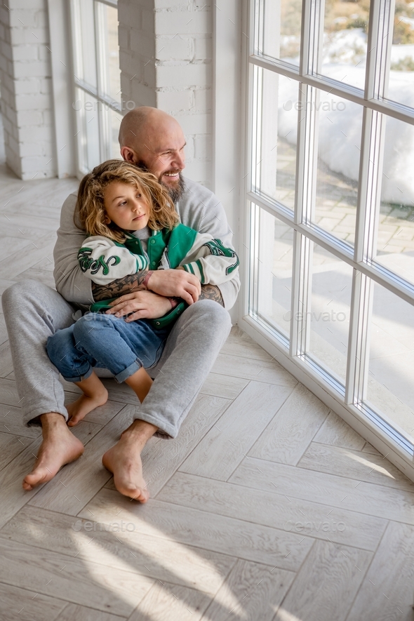 brutal bald dad with a beard and handsome boy with curly hair Stock ...
