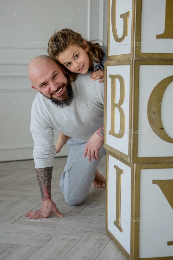 brutal bald dad and handsome curly-haired son boy 6 years old Stock ...