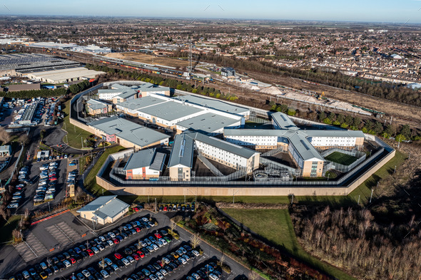 Aerial view of HMP and YOI Peterborough with prison cell buildings and ...