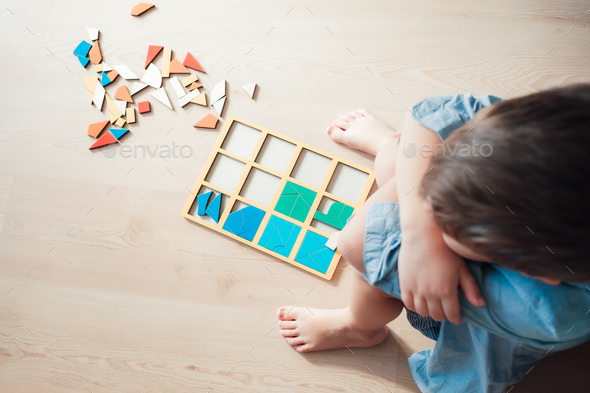 Sad boy sitting with unsolved puzzle Stock Photo by OlgaKhorkova ...