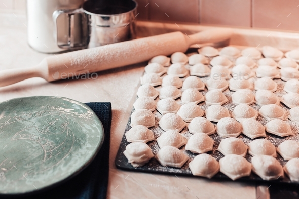 Preparations of dumplings, rolling pin and an empty plate Stock Photo ...